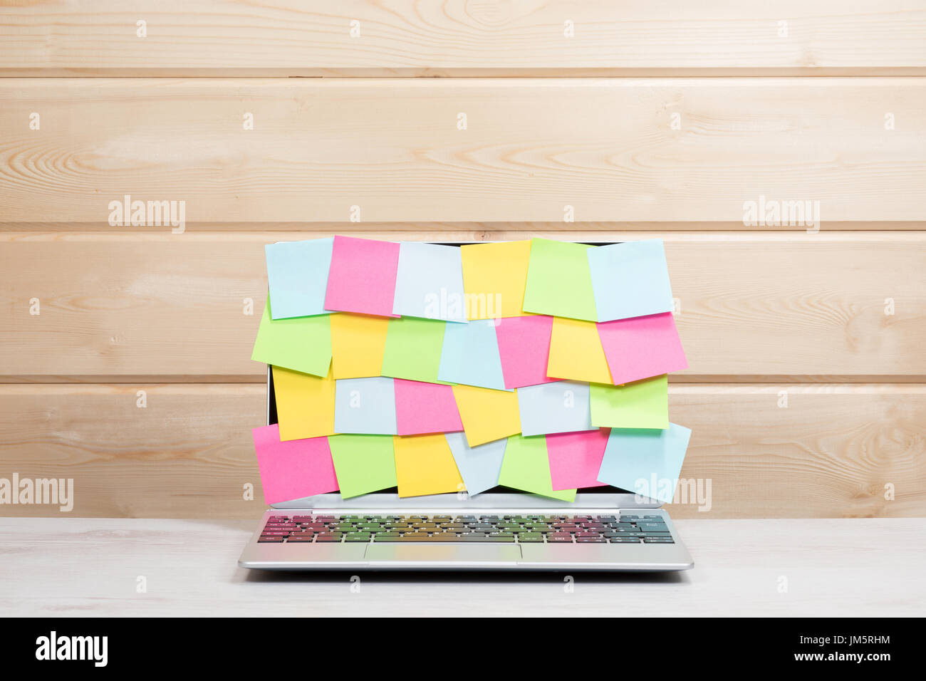 Collection of colorful blank sticky memos stuck to the screen on a ...