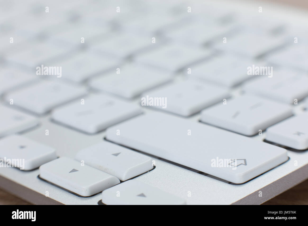 Background view of a white laptop keyboard in a low angle oblique view ...