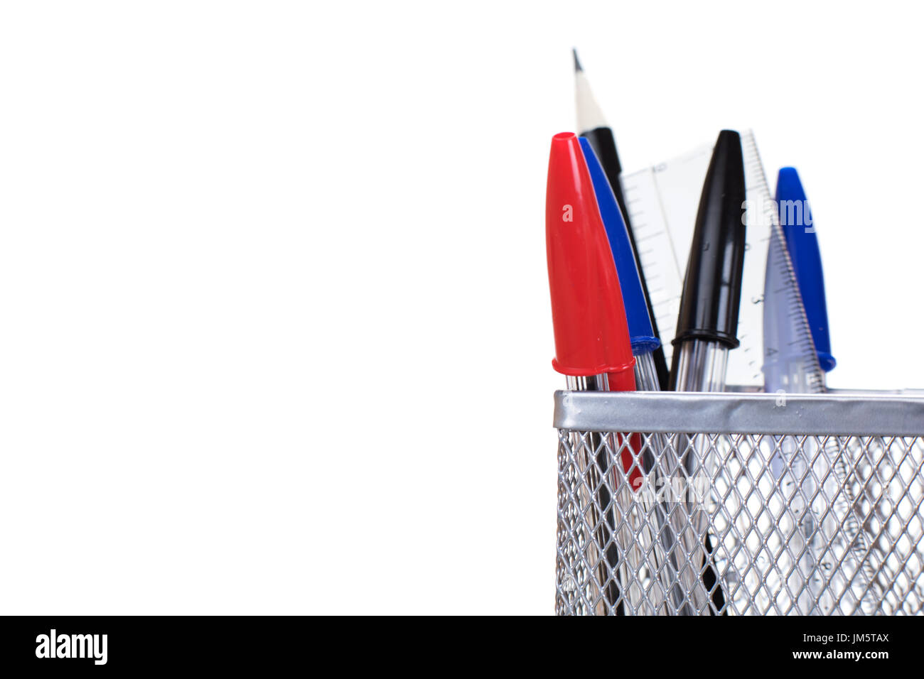 Wire mesh desk tidy with three red, blue and black ballpoint pens, a ...