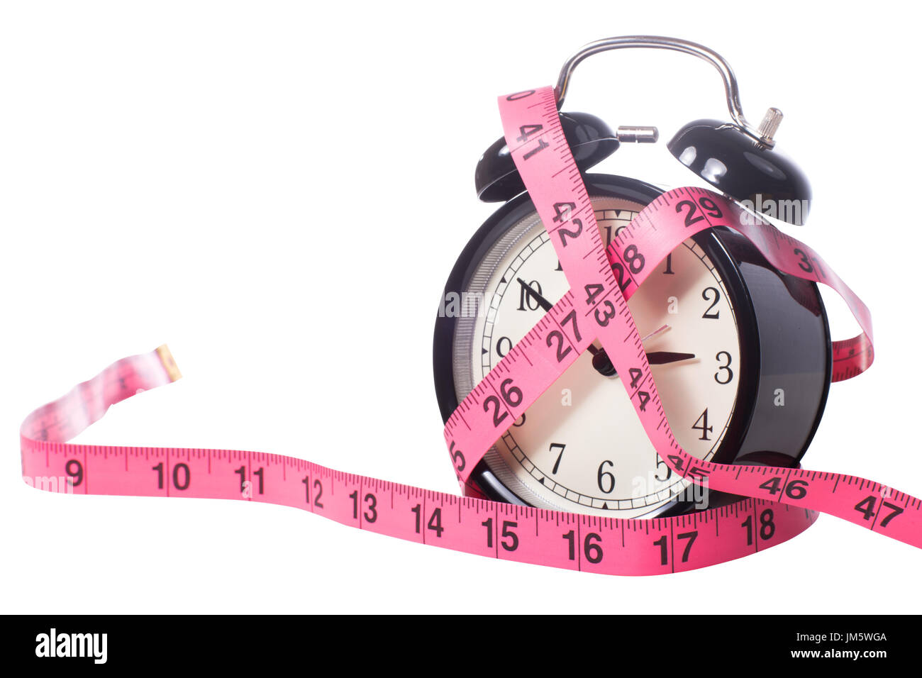 Retro alarm clock wound in a red tape measure in a conceptual image ...