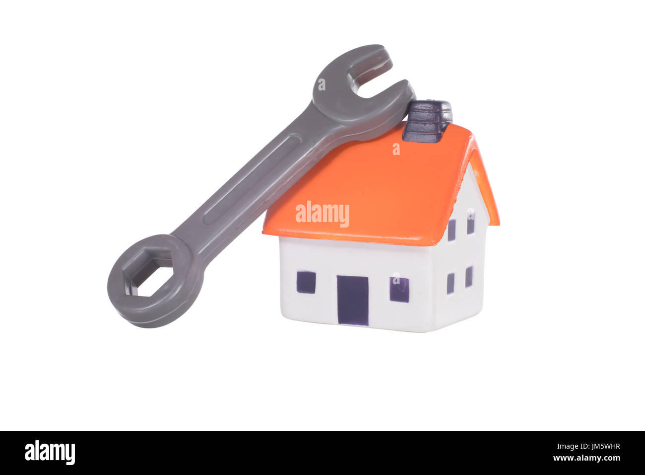 Toy model house with a small spanner in a concept of DIY, construction ...