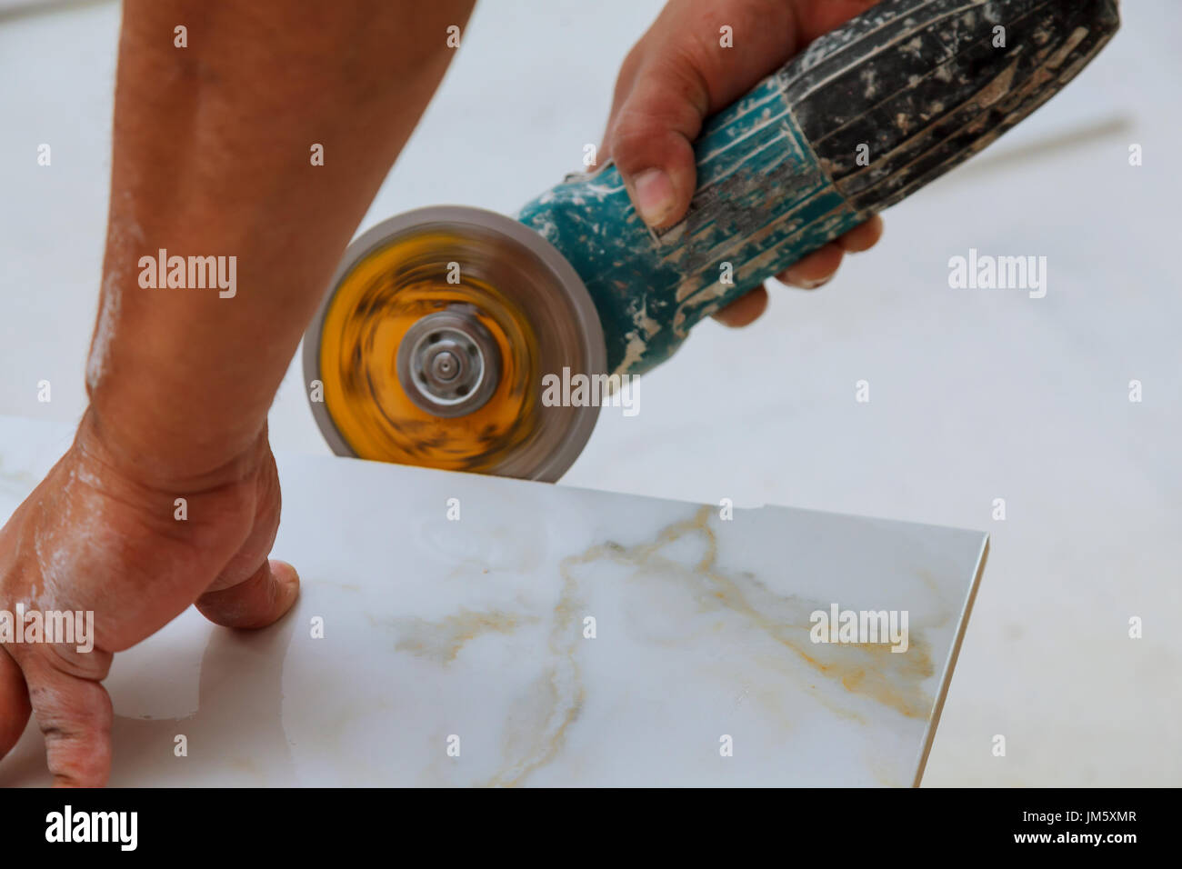 industrial tiler builder worker installing floor tile at repair ...
