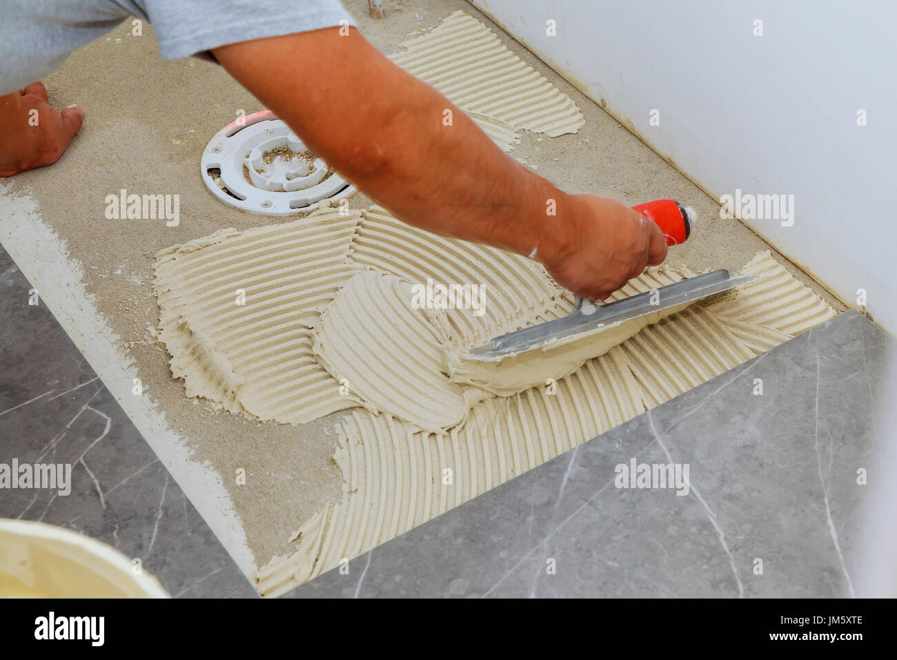 The master the tile industrial tiler builder worker installing floor ...