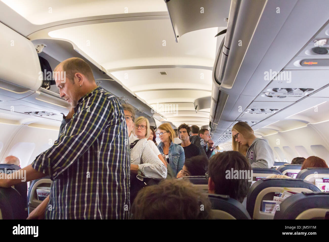 Airplane seat crowded hi-res stock photography and images - Alamy