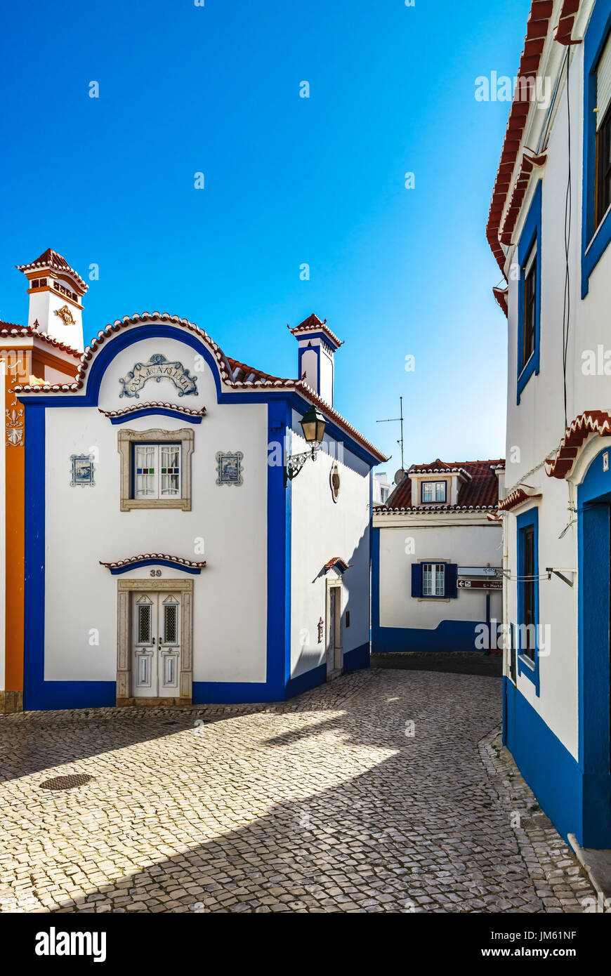 Blue color on the sky and buildings of old city Ericeira, Portugal ...