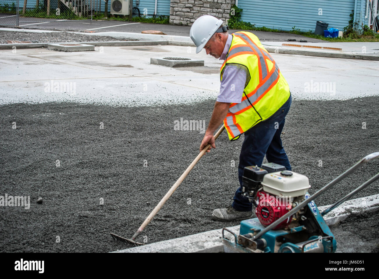 Canadian industrial construction workers laying paving on streets in ...