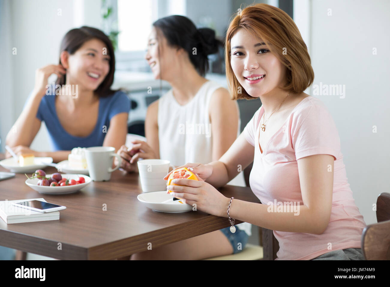 Best female friends having afternoon tea at home Stock Photo - Alamy
