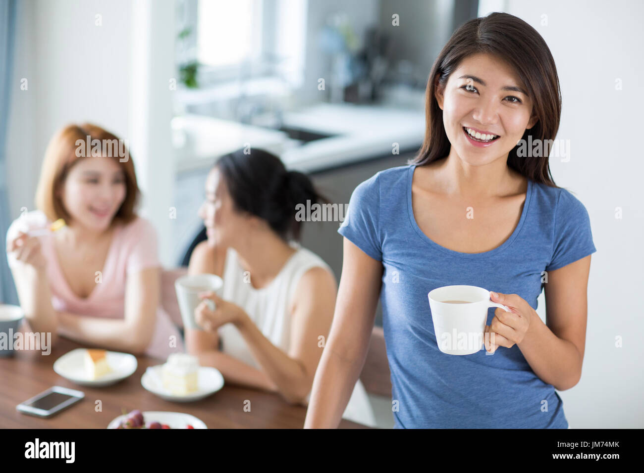 Best female friends having afternoon tea at home Stock Photo - Alamy