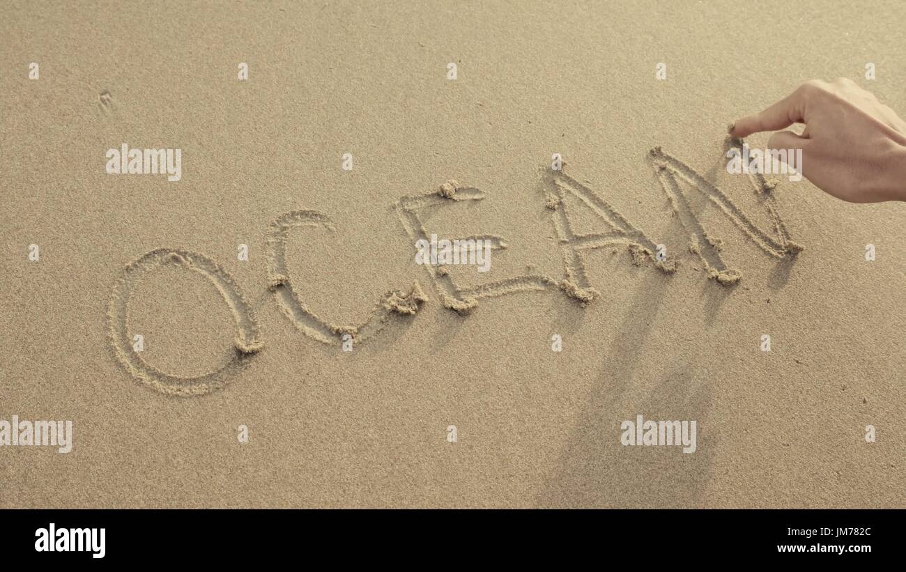 OCEAN written on the beach sand washed aways by waves Stock Photo - Alamy