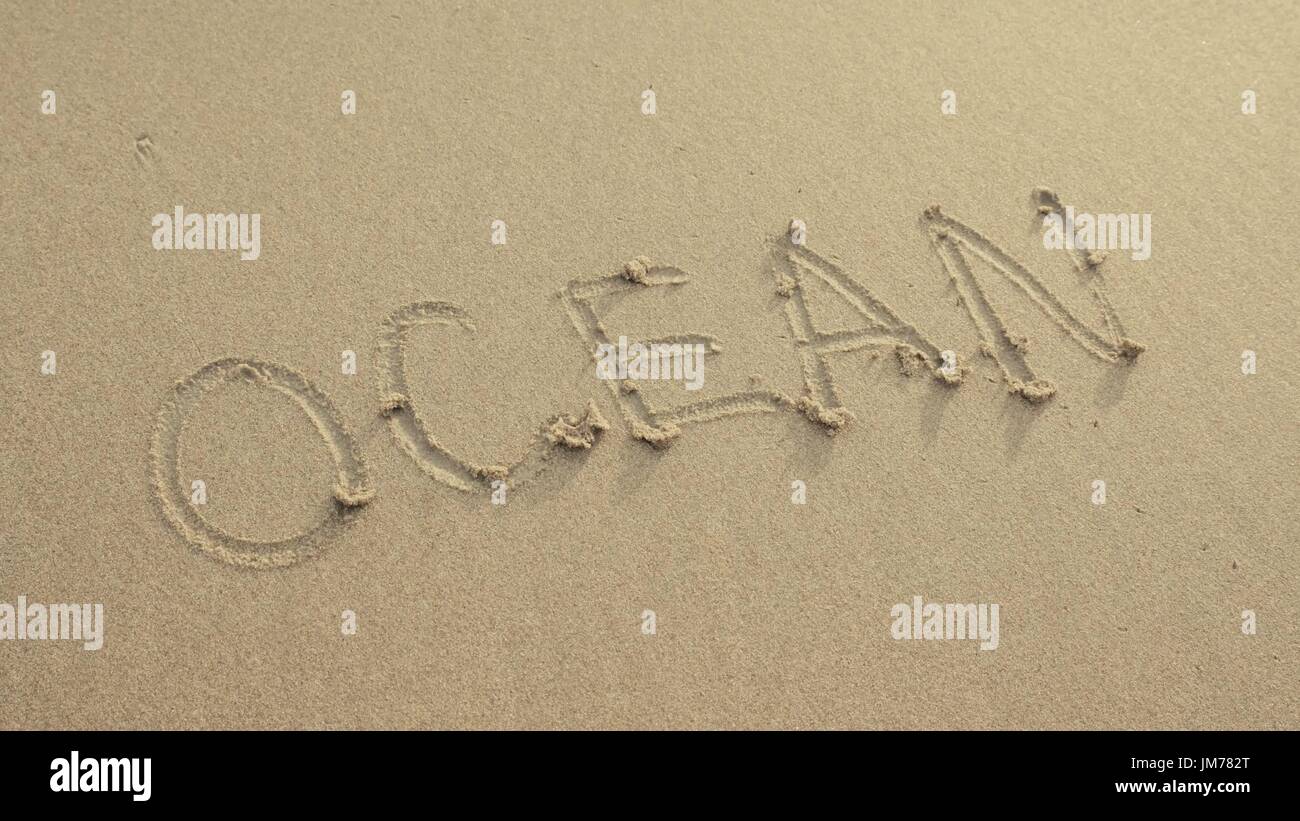OCEAN written on the beach sand washed aways by waves Stock Photo - Alamy