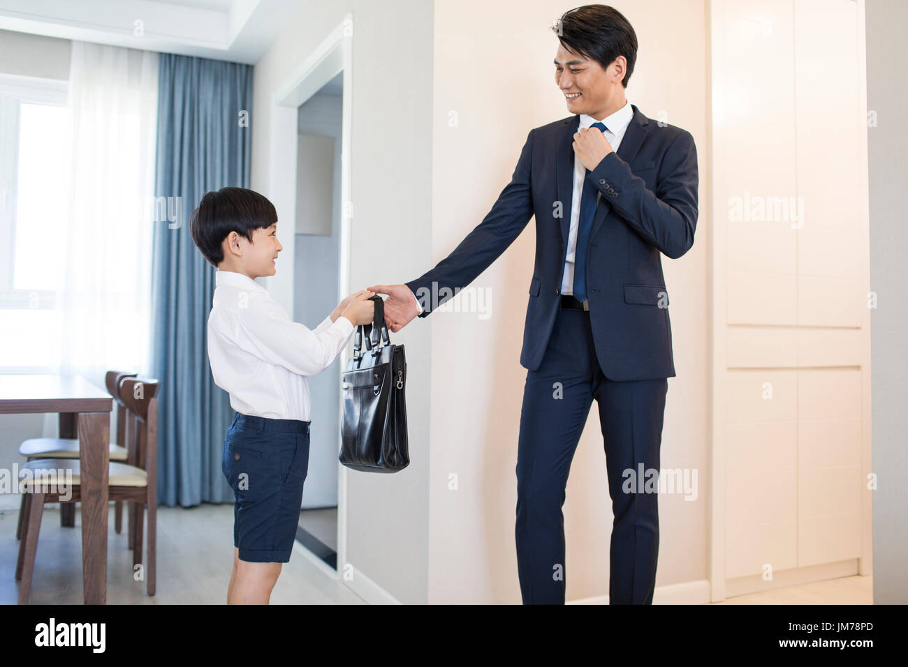 Young Chinese father leaving for work Stock Photo - Alamy