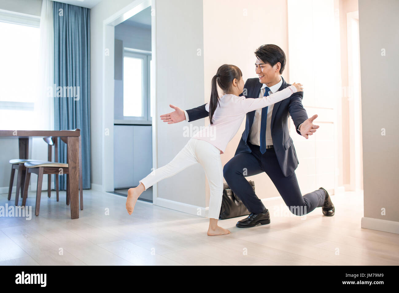 Young Chinese father come back home from work Stock Photo - Alamy