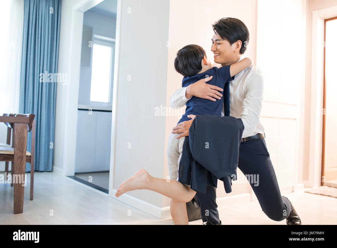 Young Chinese father come back home from work Stock Photo - Alamy