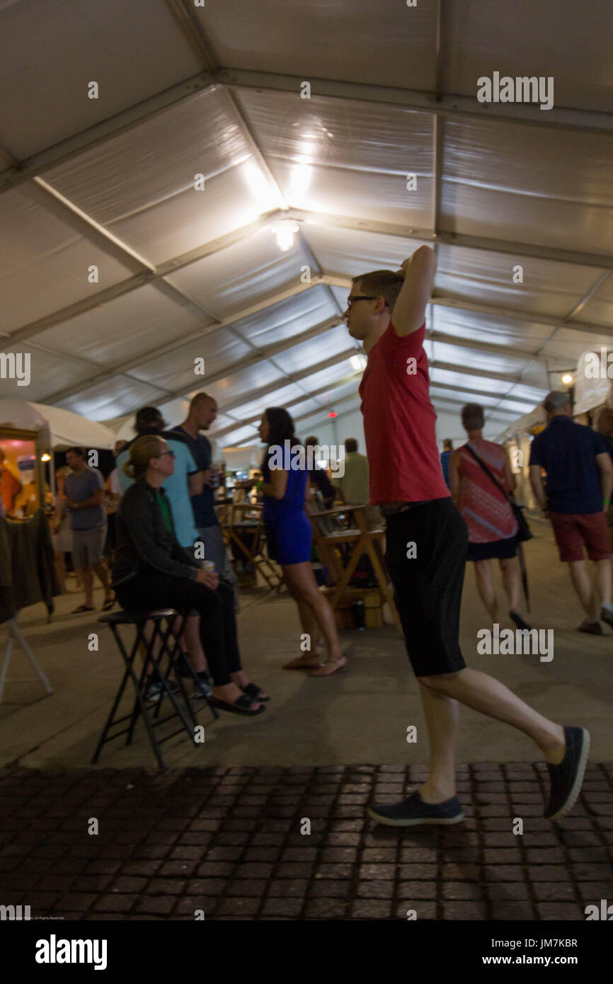 walking through a crow with arms stretched over his head Stock Photo ...