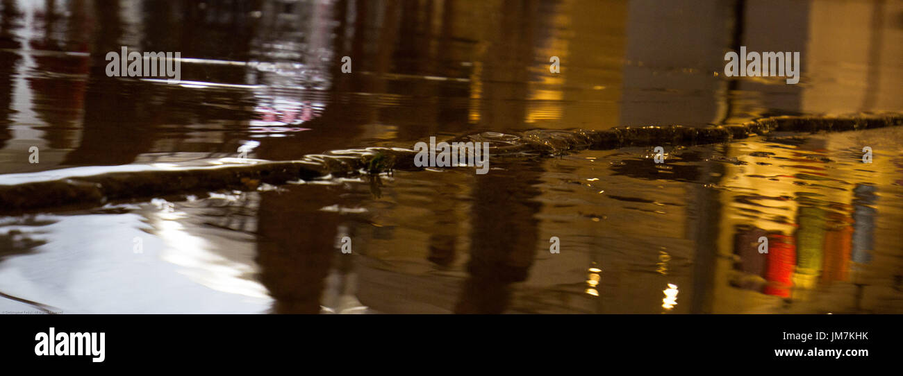 Long image of water passing by sidewalk Stock Photo - Alamy