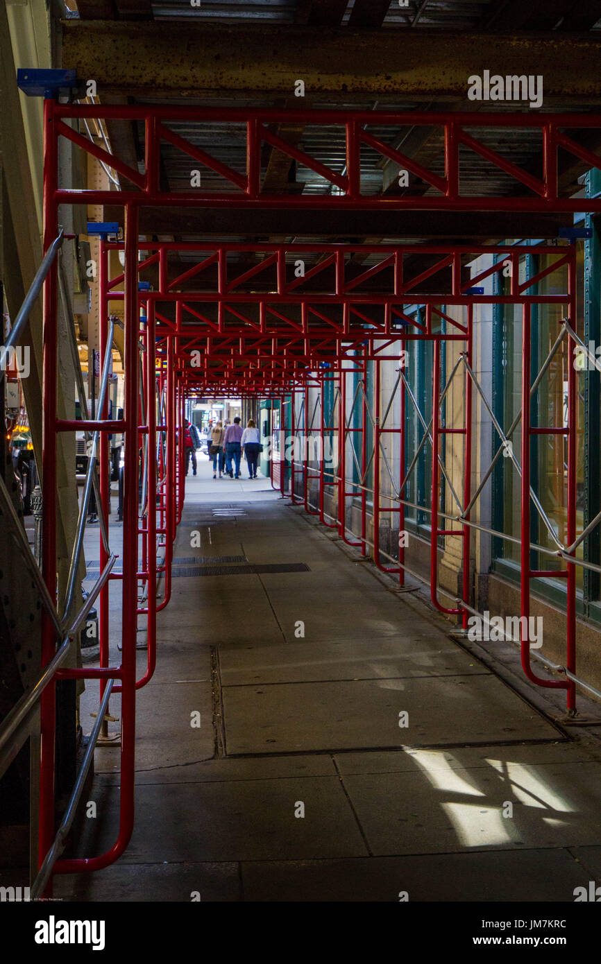 Red scaffolding over city sidewalk Stock Photo - Alamy