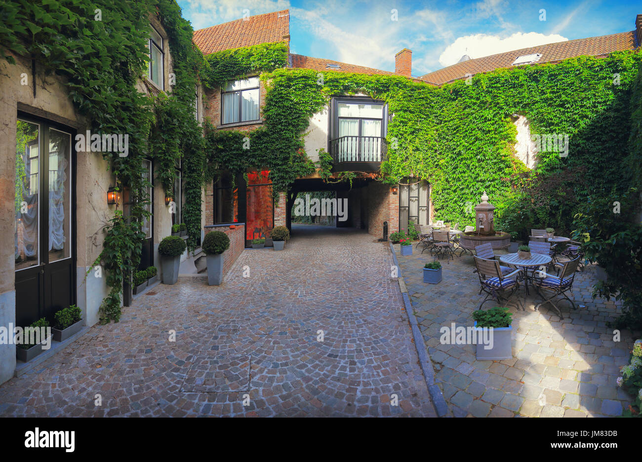 Belgium courtyard in historical centre of Bruges. Cozy backyard with ...