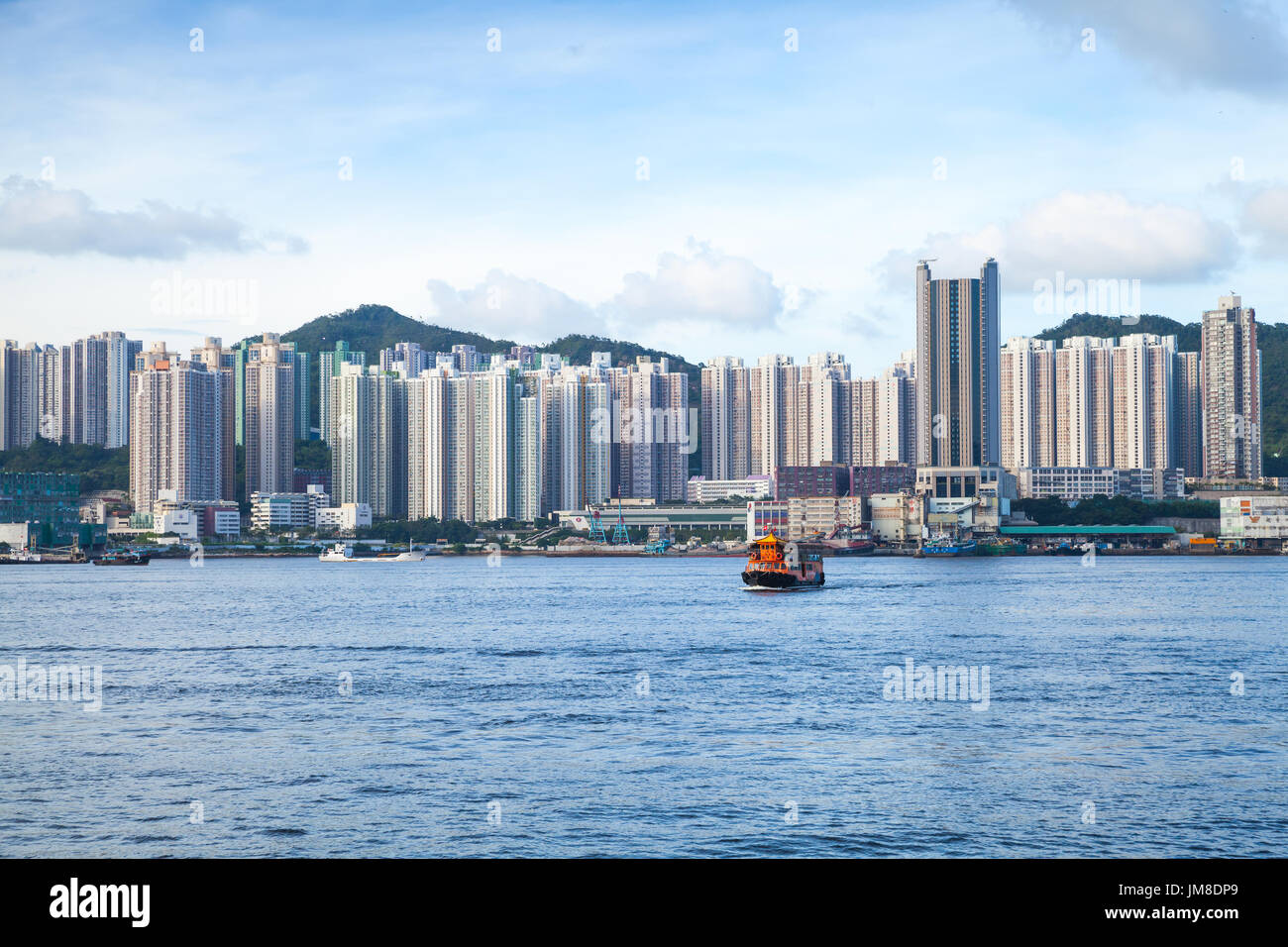 Hong Kong - July 10, 2017: Orange passenger ferry goes near Sai Wan Ho ...