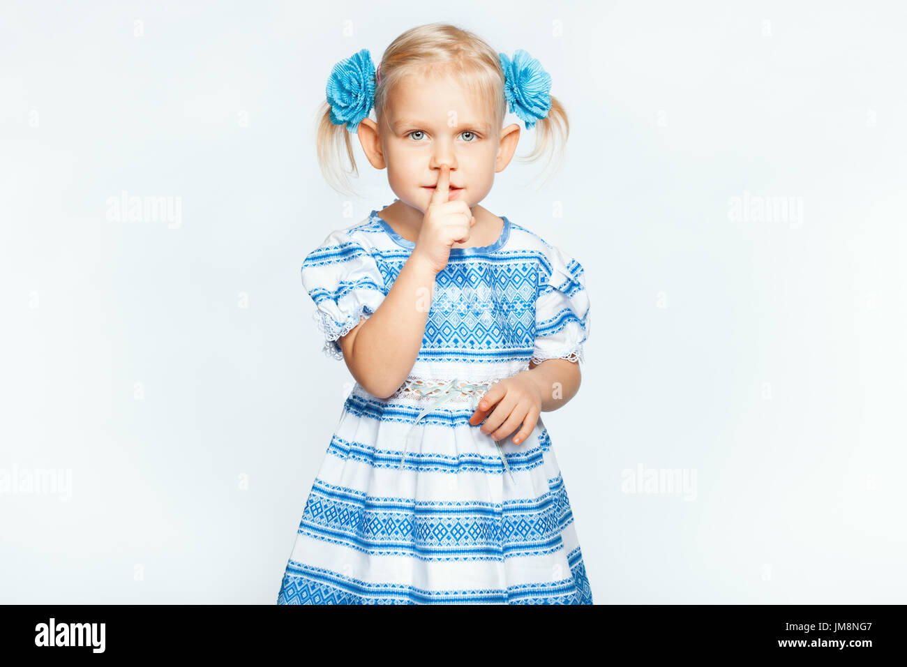Little beautiful blond girl on a white background making shh Stock ...