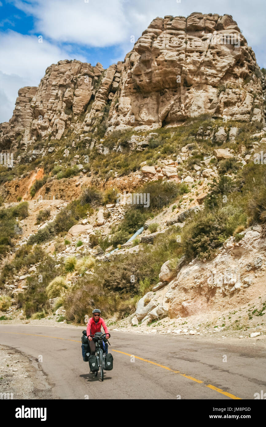 Woman cycling on the famous national Ruta 40 quarenta in the remote ...