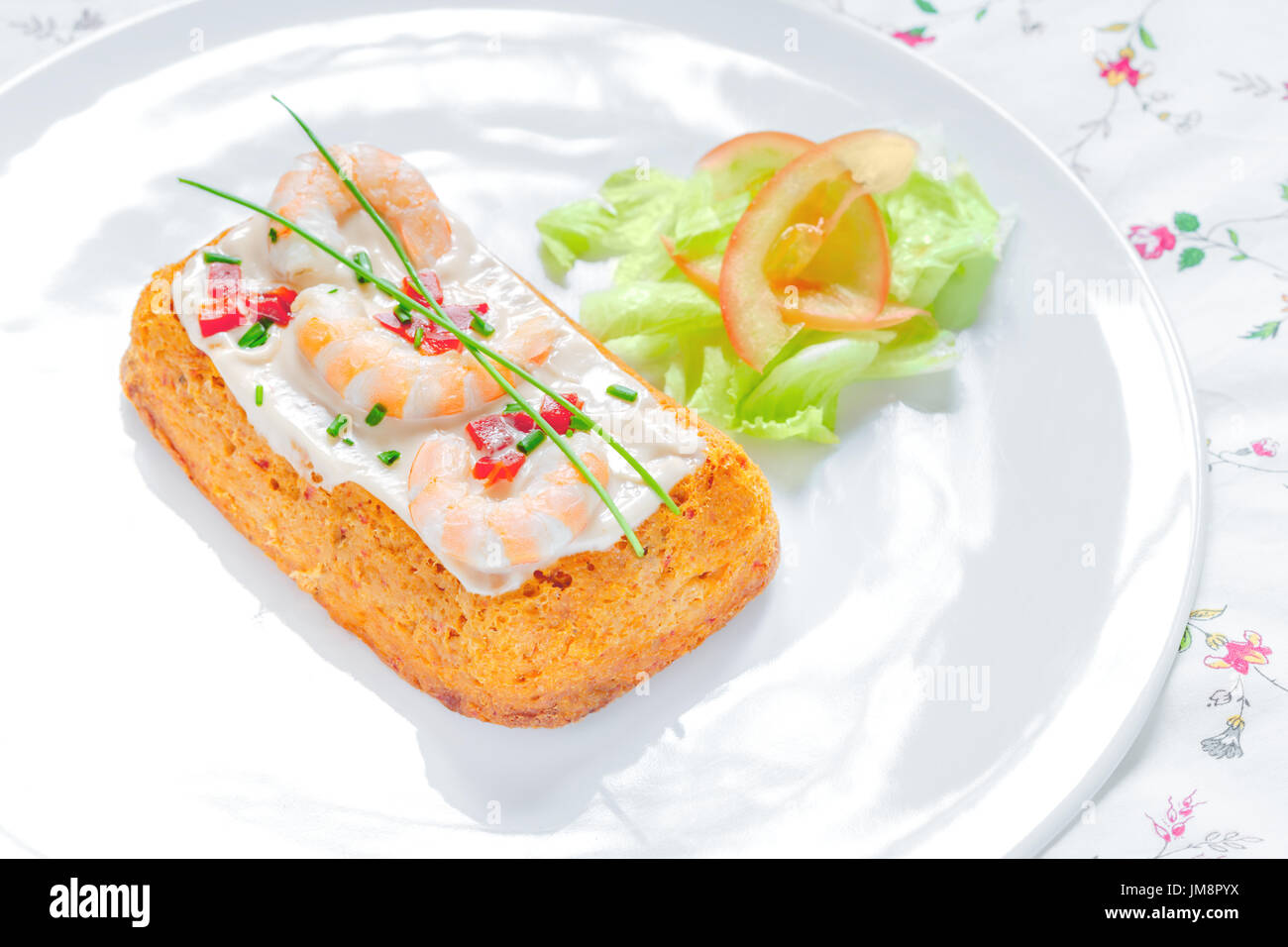 Delicious Fish cake. Hake cake with tomato, shrimps, chive and salad ...