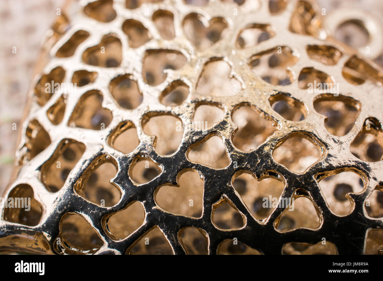 Heart shaped gold color metal object on canvas Stock Photo - Alamy
