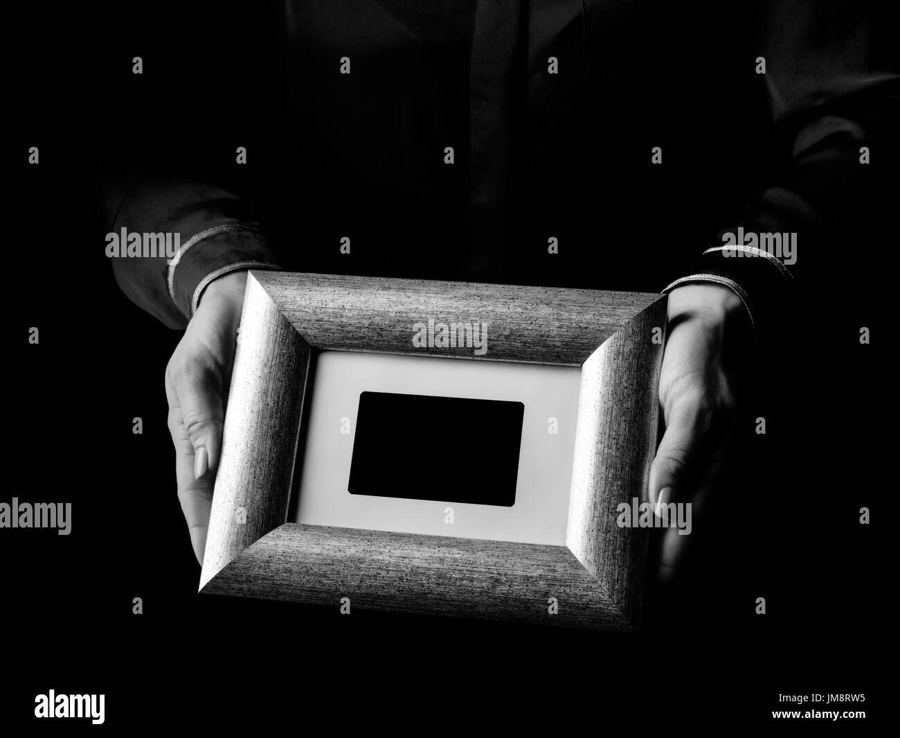 Black Mania. female hands isolated on black background showing a photo ...