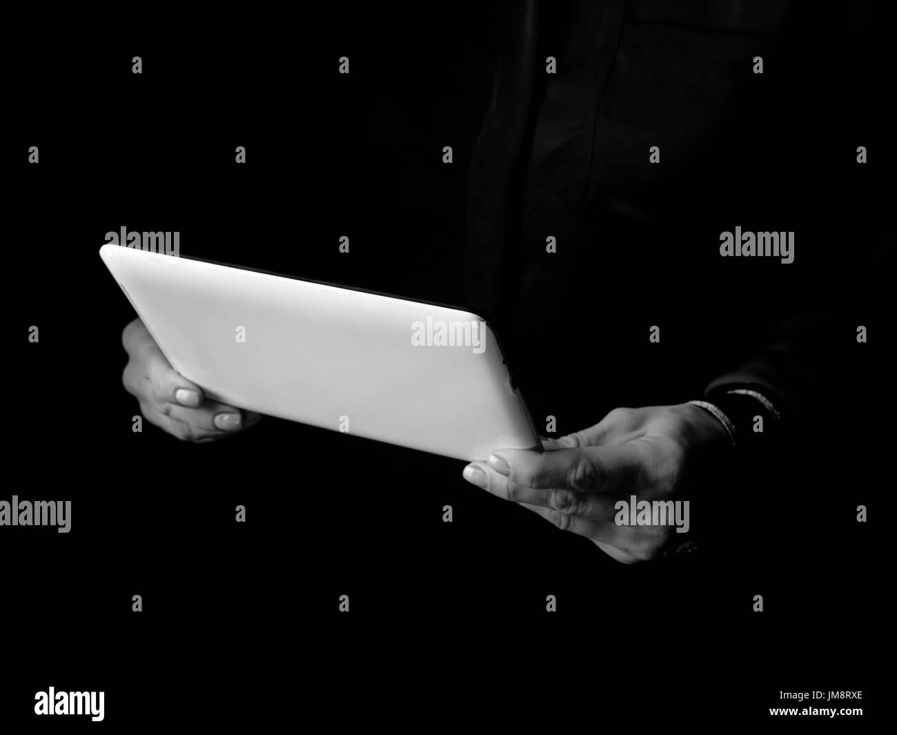 Black Mania. woman hands isolated on black using tablet PC Stock Photo ...