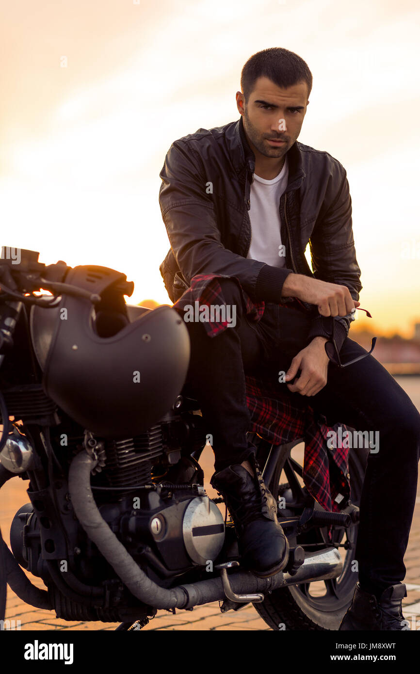 Handsome rider man with beard and mustache in black leather biker ...