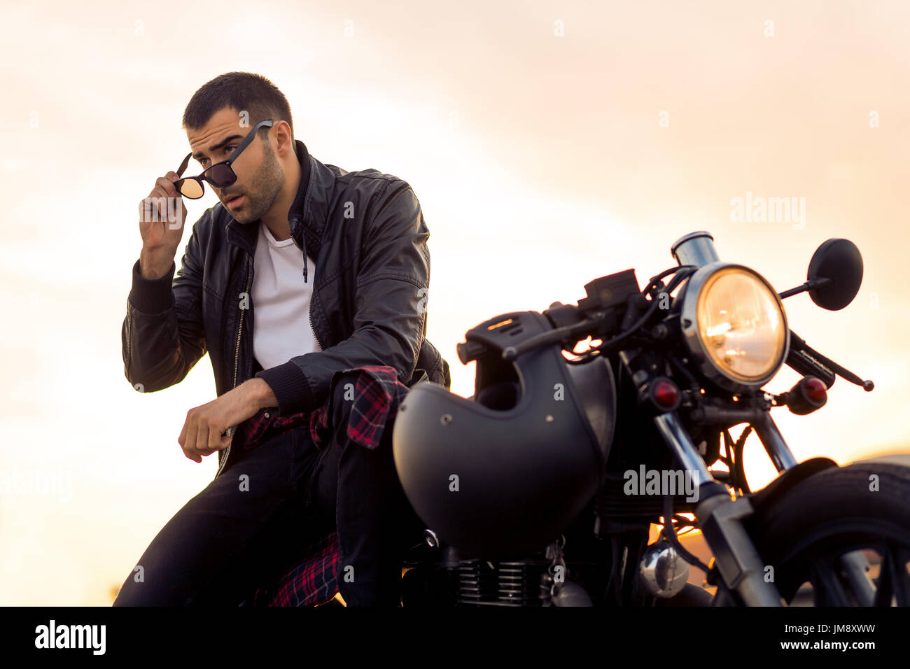 Handsome rider man with beard and mustache in black biker jacket take ...