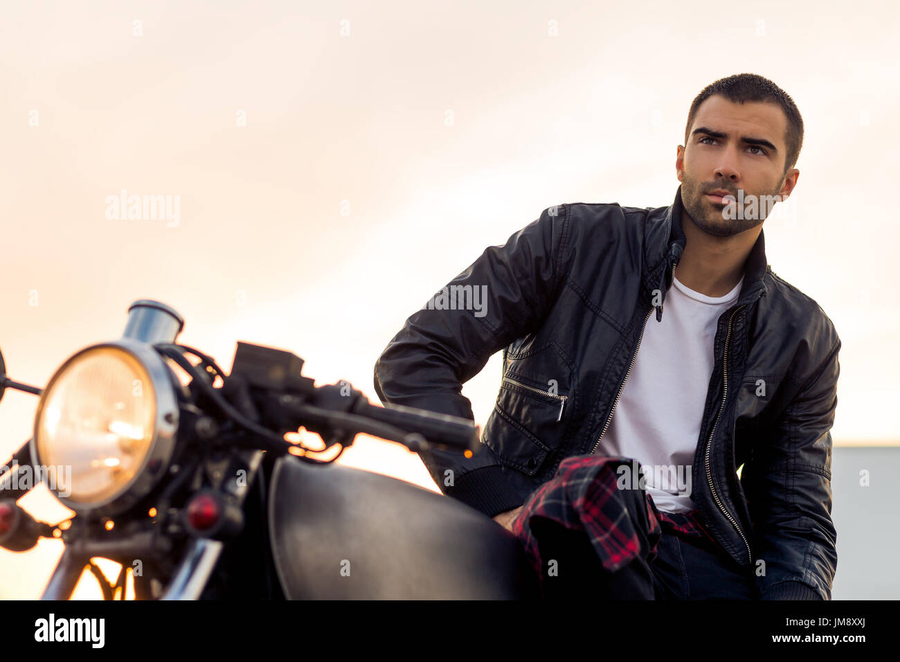 Handsome rider guy with beard and mustache in black leather biker ...