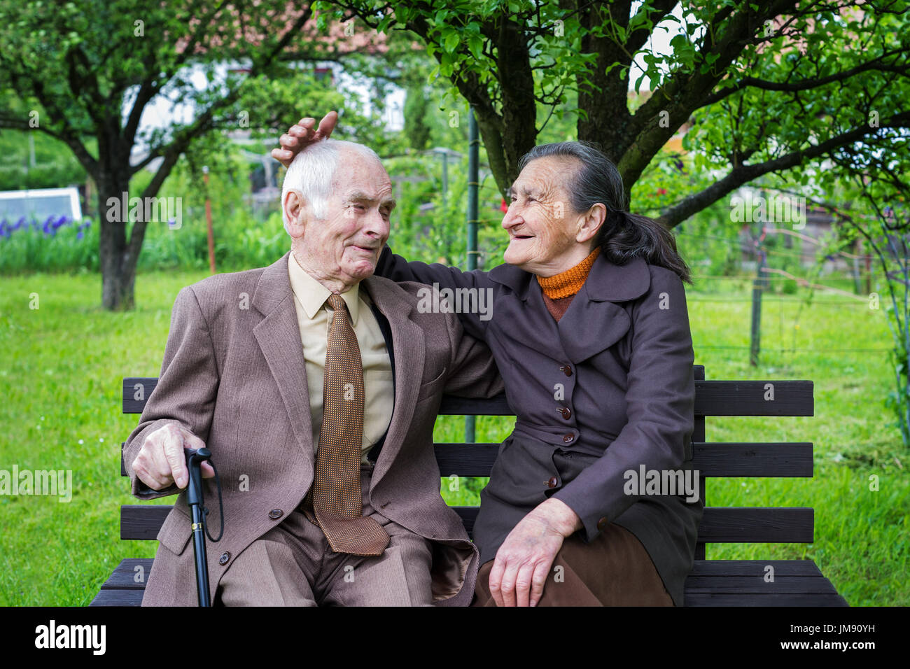 Cute 80 plus year old married couple posing for a portrait in their ...