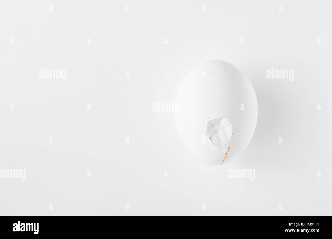 Broken egg on white background Stock Photo - Alamy