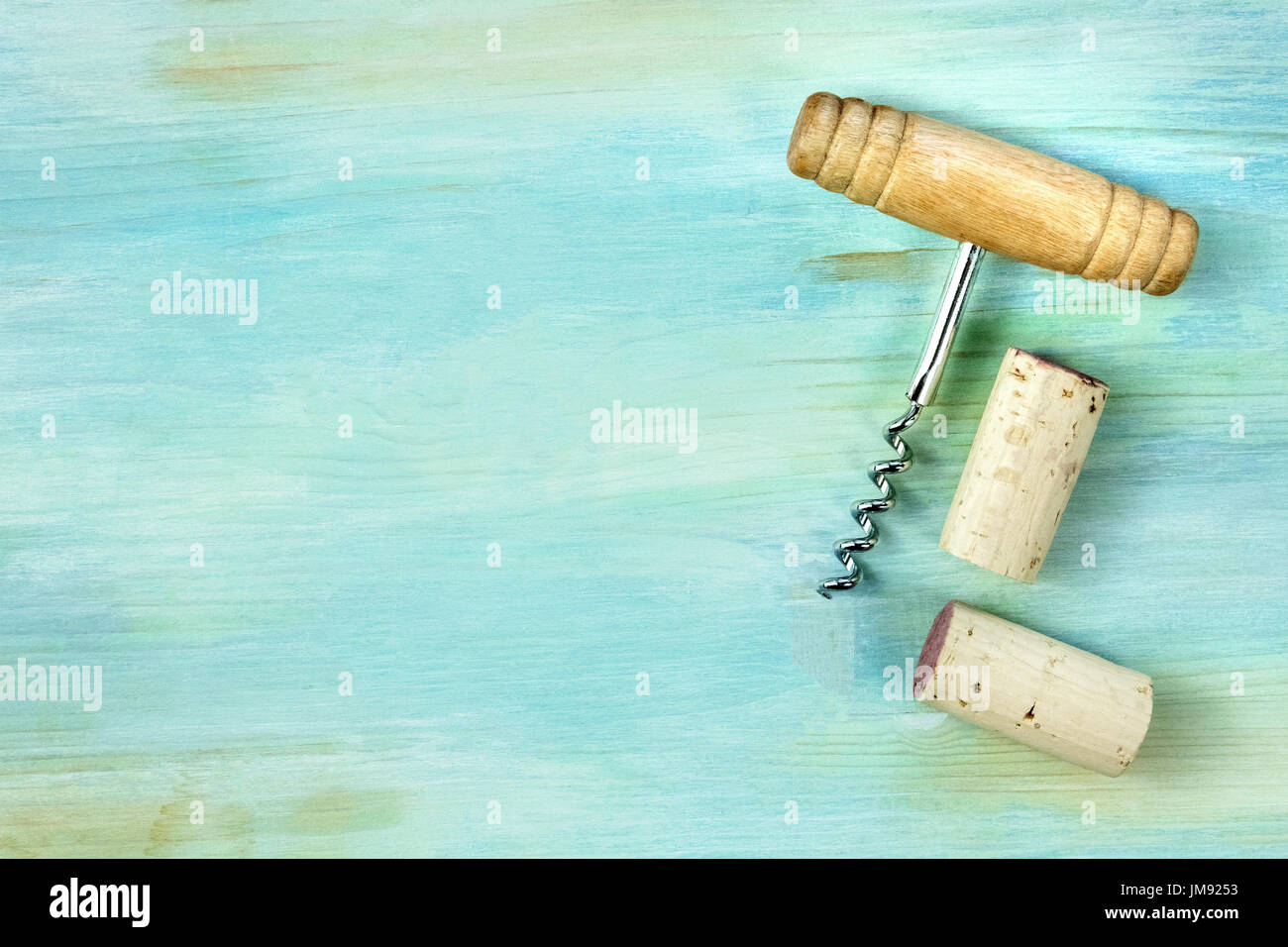 A photo of an old-fashioned corkscrew with corks, shot from above on a ...