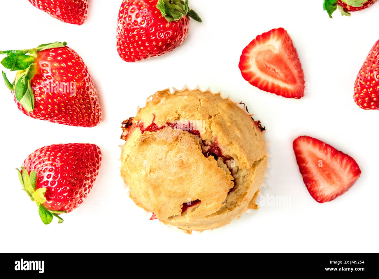 An overhead photo of a strawberry muffin with slices of strawberries ...