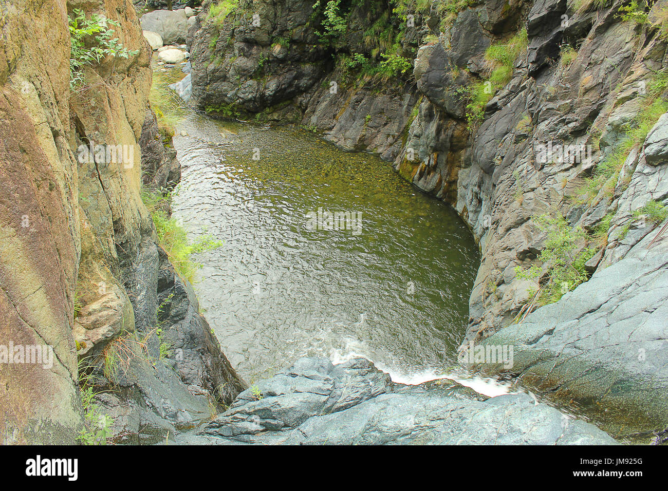 rocks around a puddle of water in mountain Stock Photo - Alamy