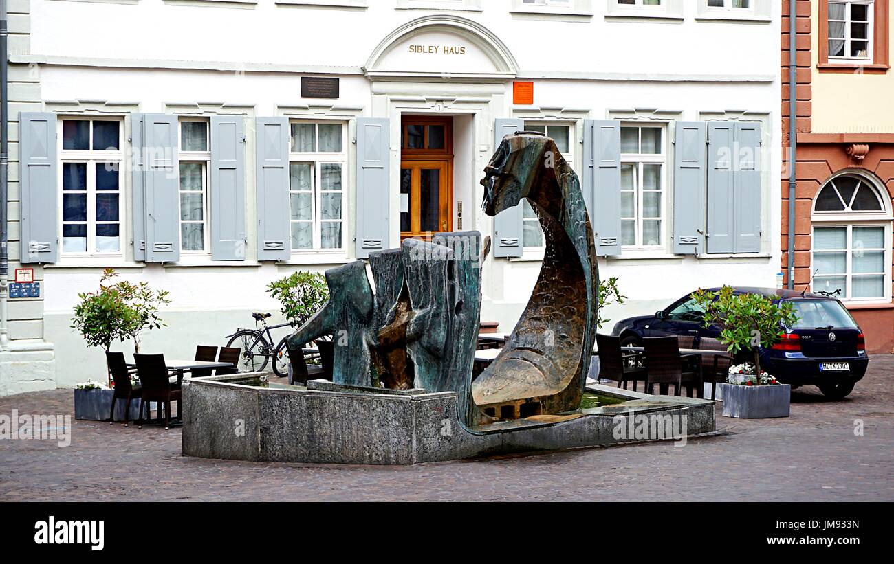 Dragon sculpture in the fountain in front of buildings in old town ...