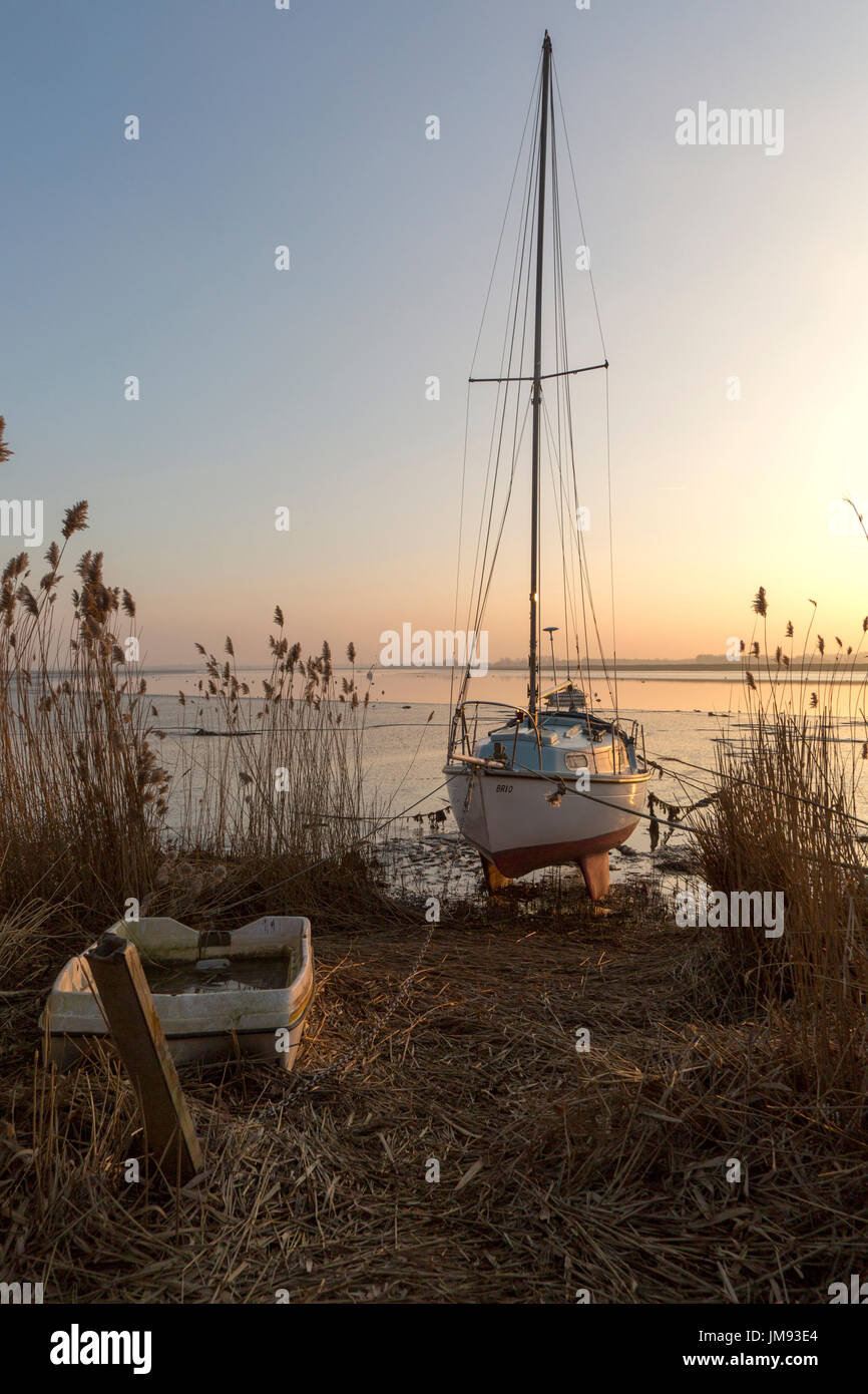 Yacht at moorings winter sunset, River Deben, Ramsholt, Suffolk ...