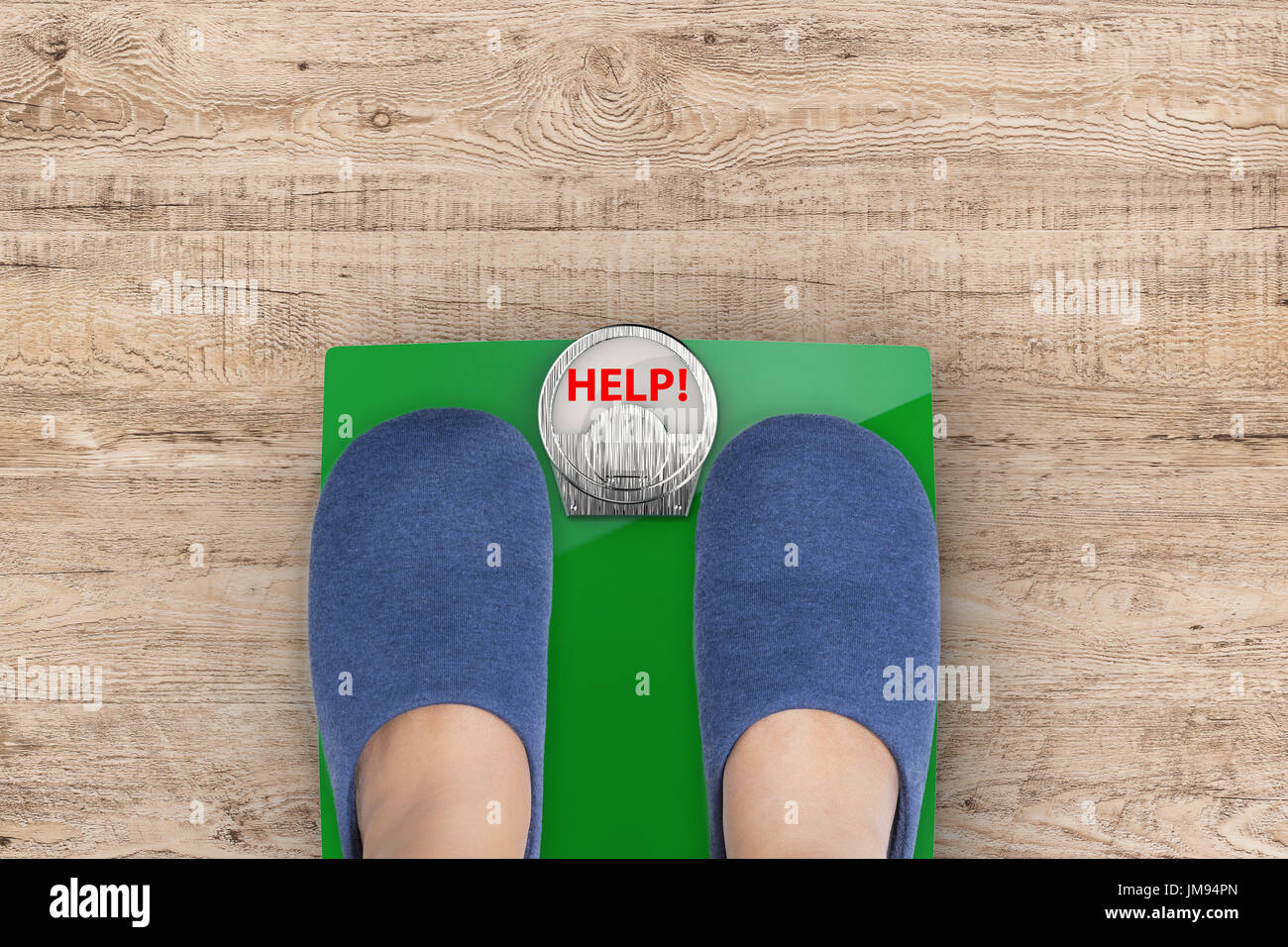foot standing on weight scales with text "help Stock Photo - Alamy