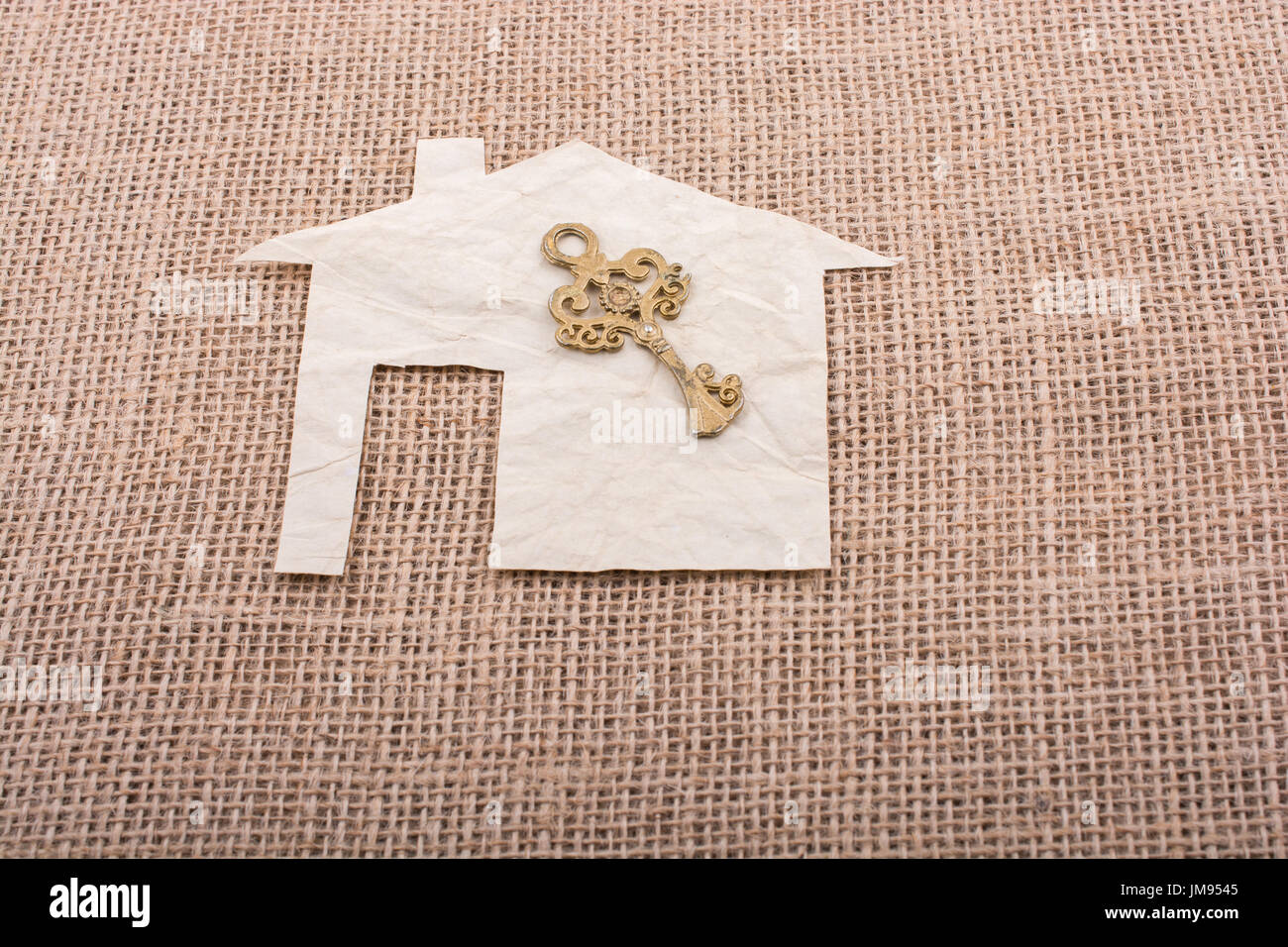 Retro key on a house shape on a canvas background Stock Photo - Alamy