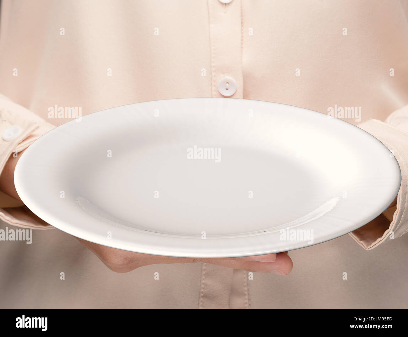 hand holding empty white dish Stock Photo - Alamy