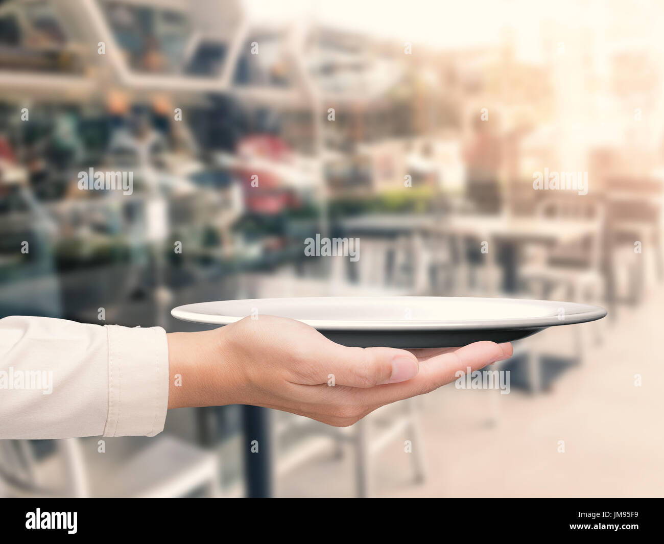 hand holding empty white dish Stock Photo - Alamy