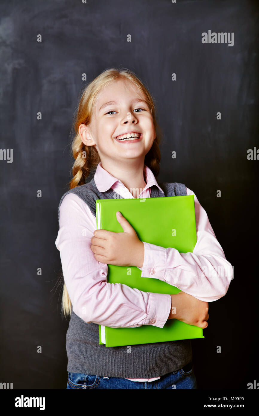 schoolchild on blackboard background Stock Photo - Alamy