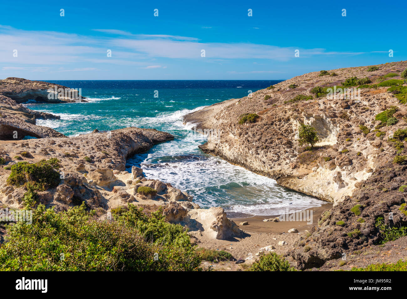 Kapros, small bay between rocks and blue sea on Milos island. Cyclades ...