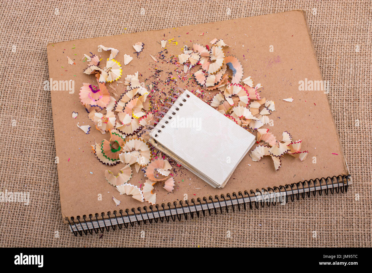 Spiral notebooks amid some colorful pencil trash Stock Photo - Alamy