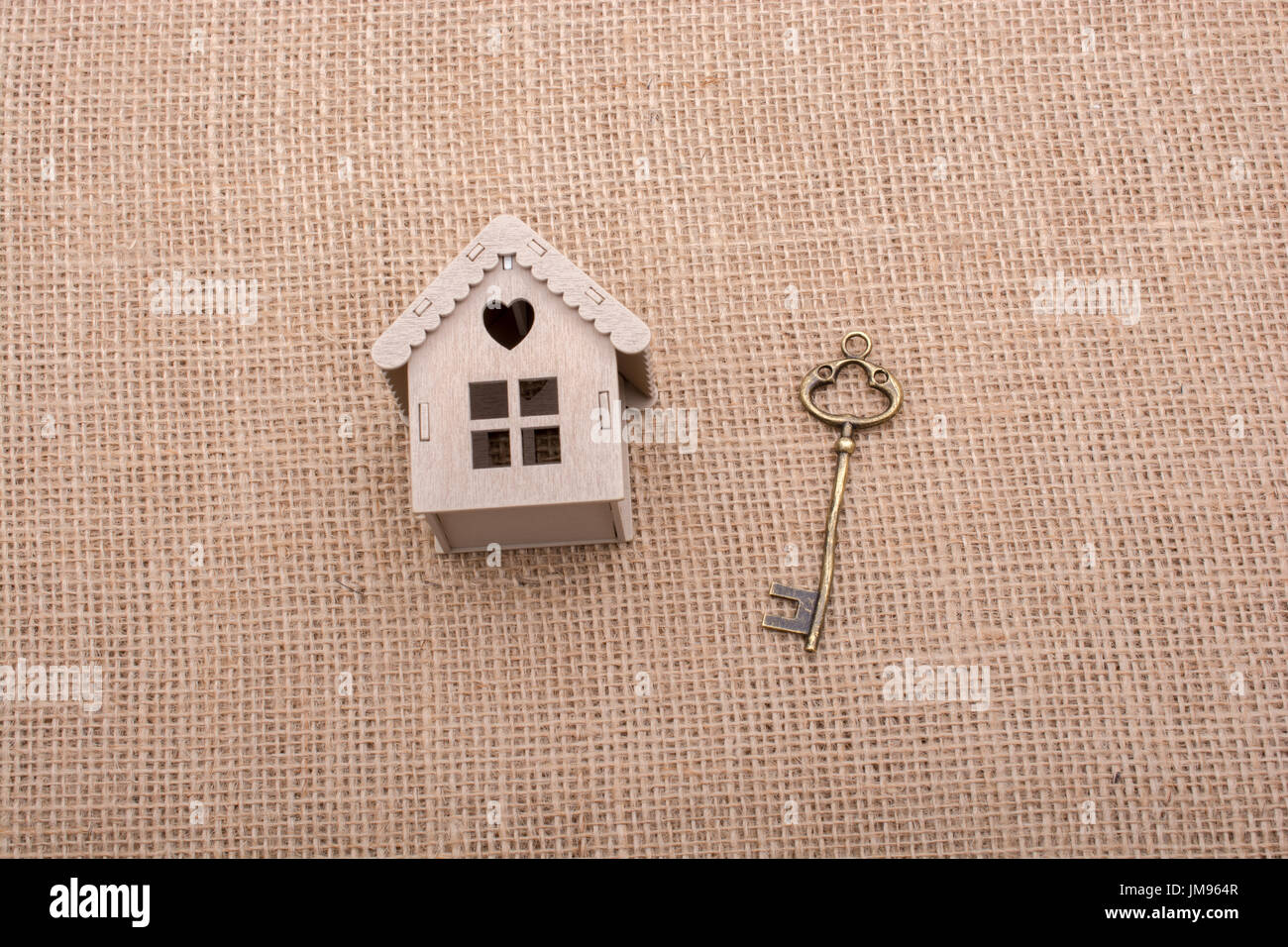 Retro key and a Model house on a canvas background Stock Photo - Alamy