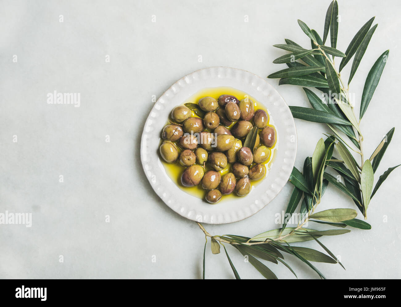 Pickled green olives in virgin oil and olive-tree branch Stock Photo ...