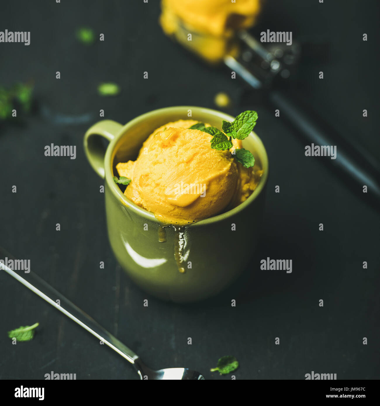 Mango sorbet ice cream scoops with fresh mint leaves Stock Photo - Alamy