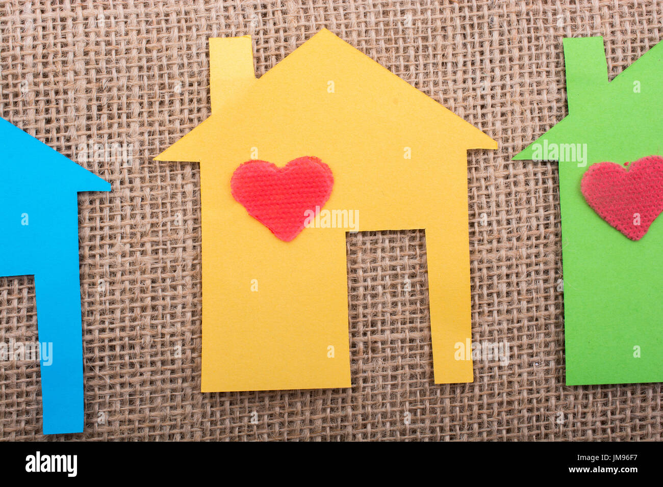 Heart shape on house shape cut out of paper with a canvas background ...