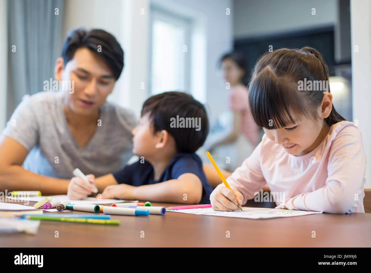 Happy Chinese siblings studying together at home Stock Photo - Alamy